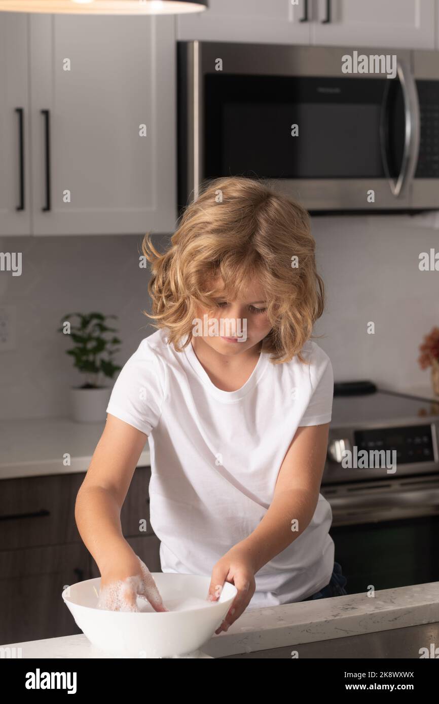 Child cleaning dishes with sponge. Cleaning supplies. Help clean-up ...