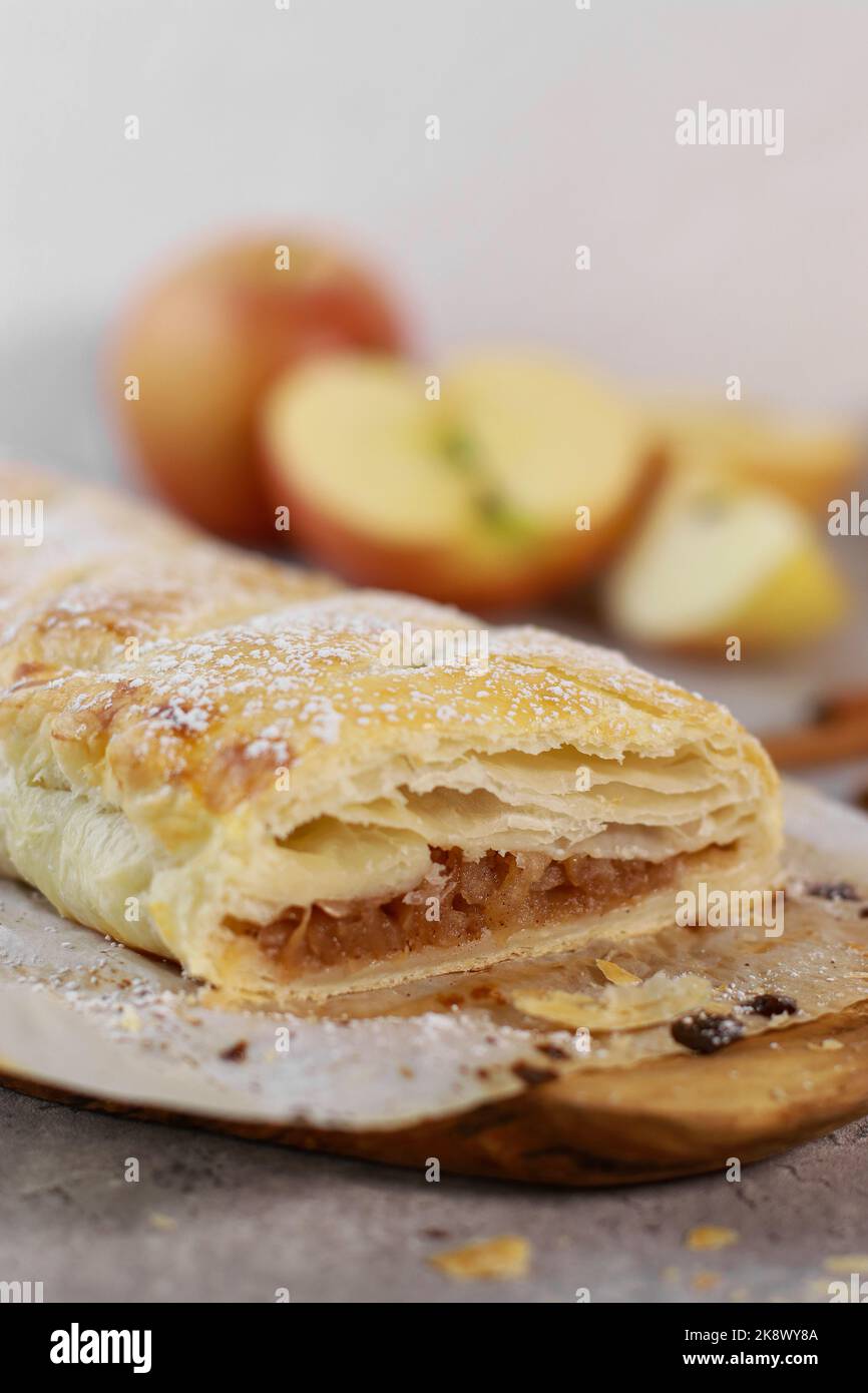 apple pastry strudel roll with cinnamon on grey marble table Stock ...