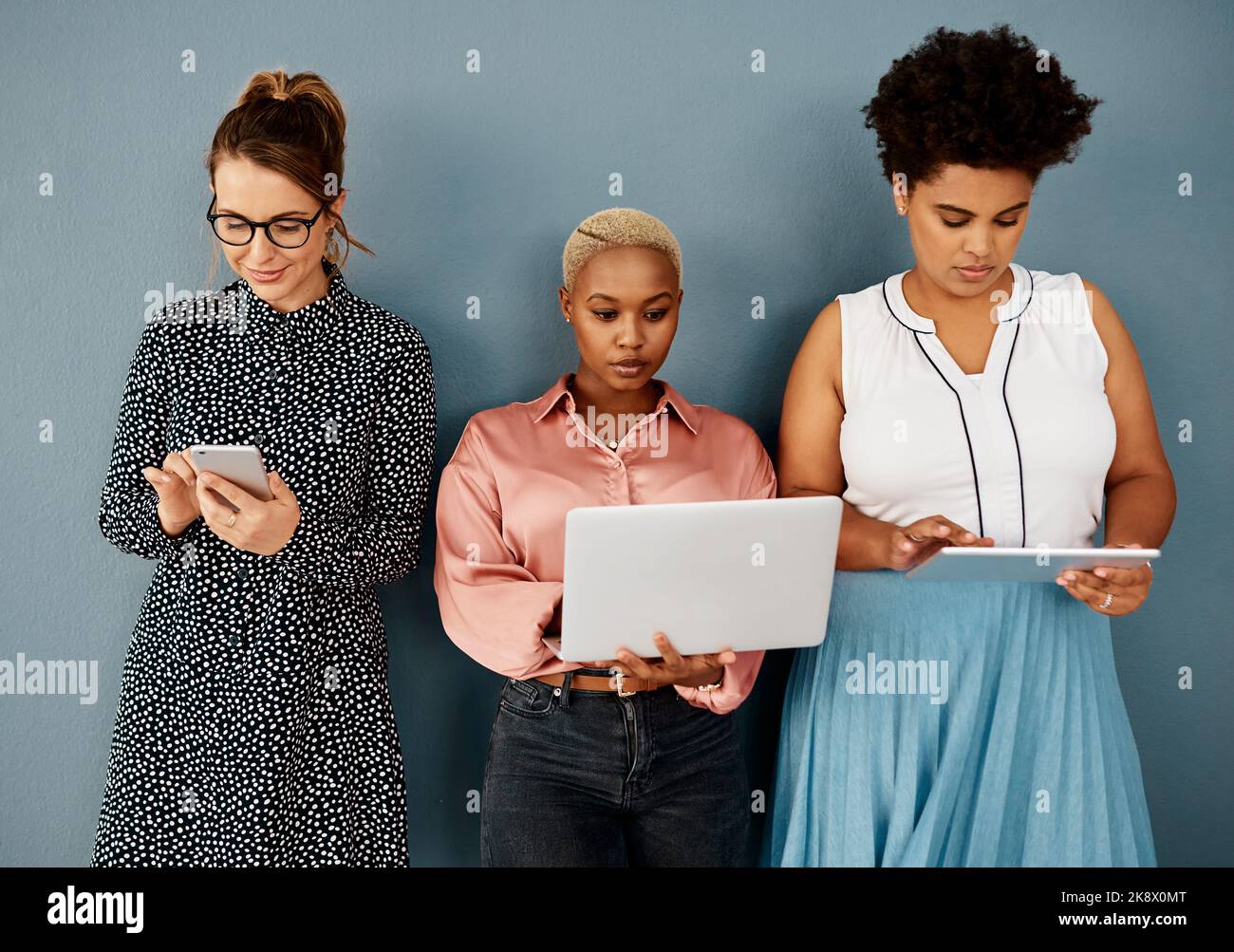 Mobile devices To each their own. Studio shot of a group of attractive ...