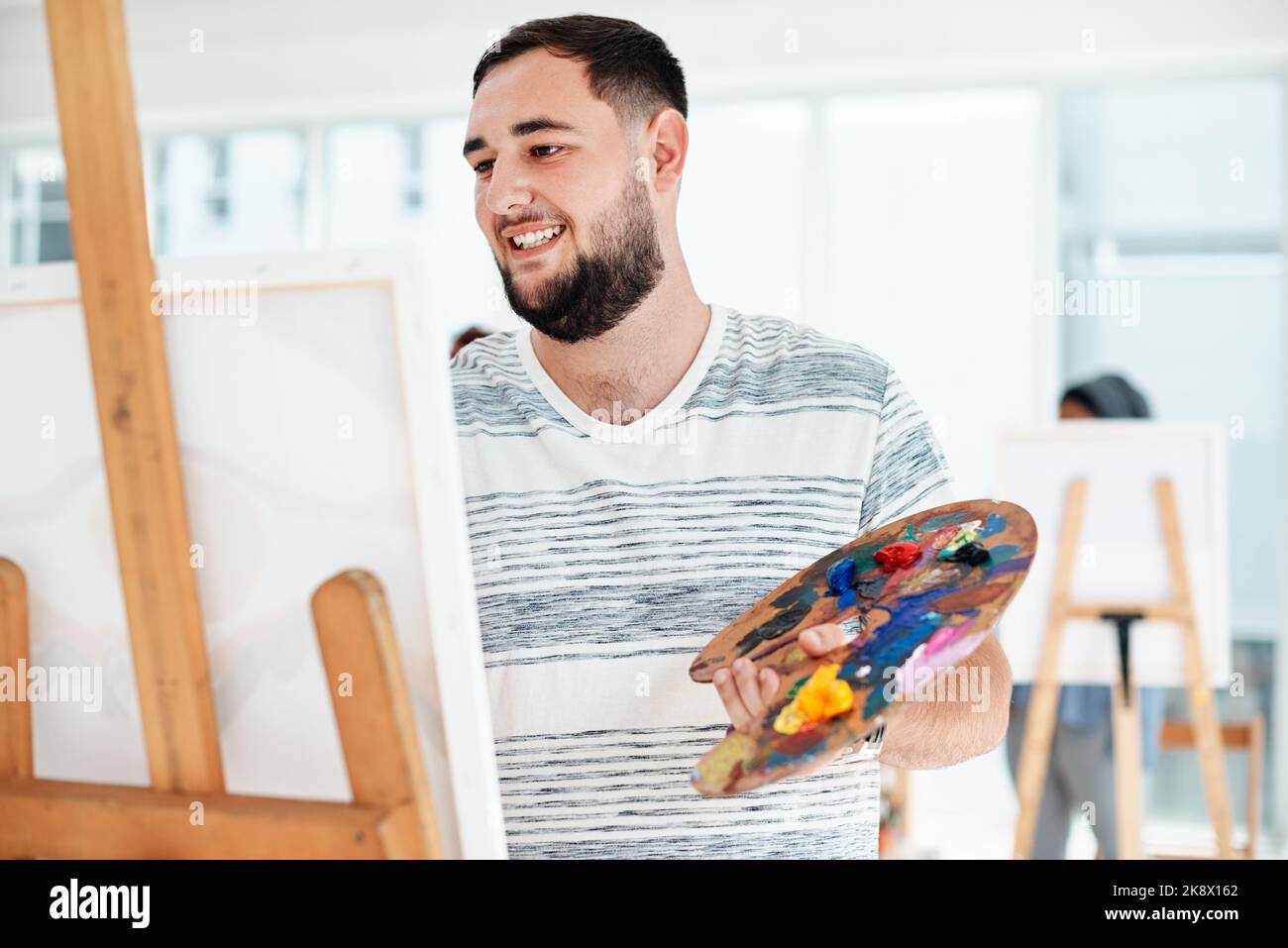 Dare to express yourself. a handsome young artist standing alone and ...