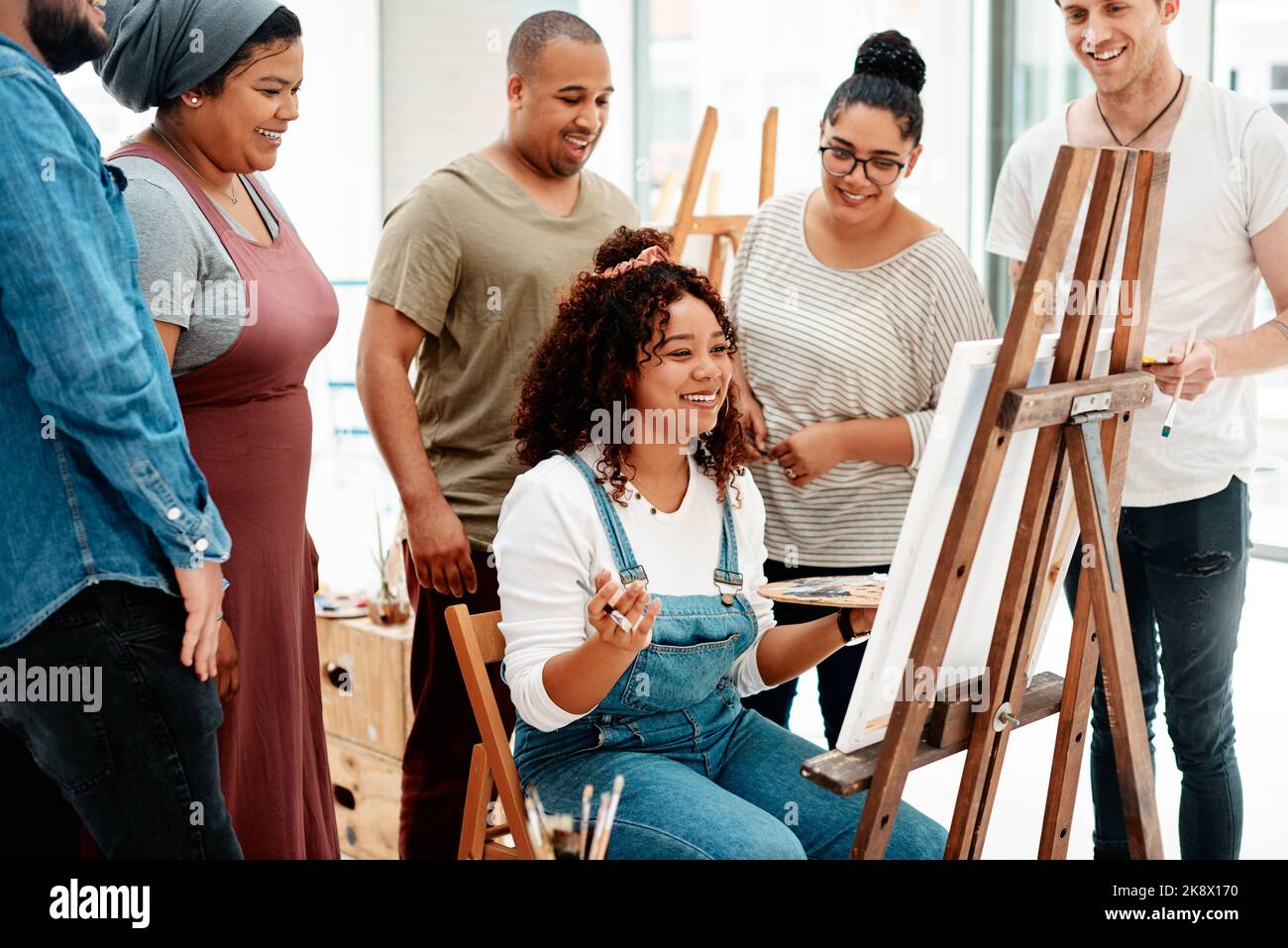 Art is what brings people together. an attractive young woman sitting ...