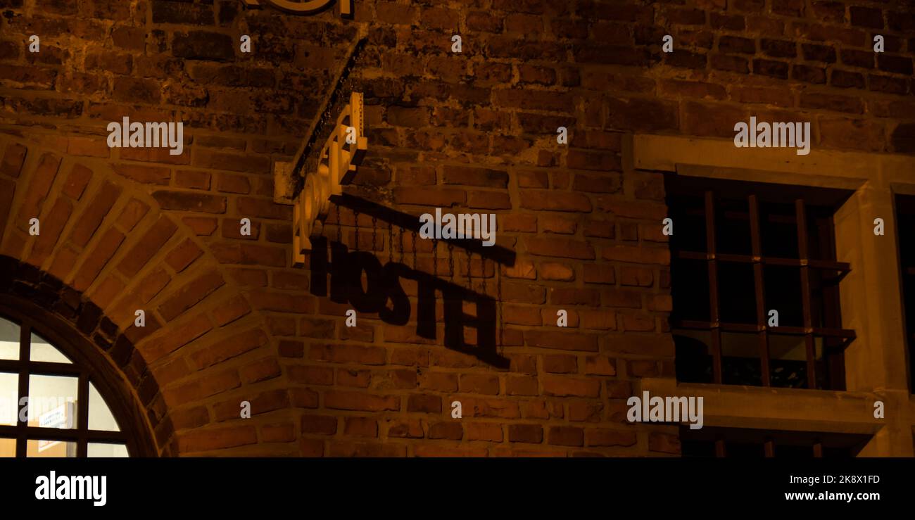 Hostel inscription in neon lights at night. Electric sign at night ...