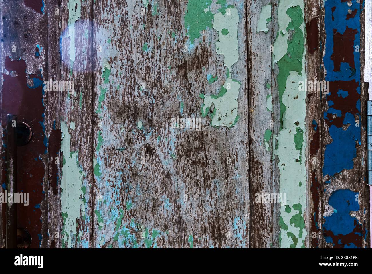Colorful craquelure of the delaminated paint on wooden door background ...