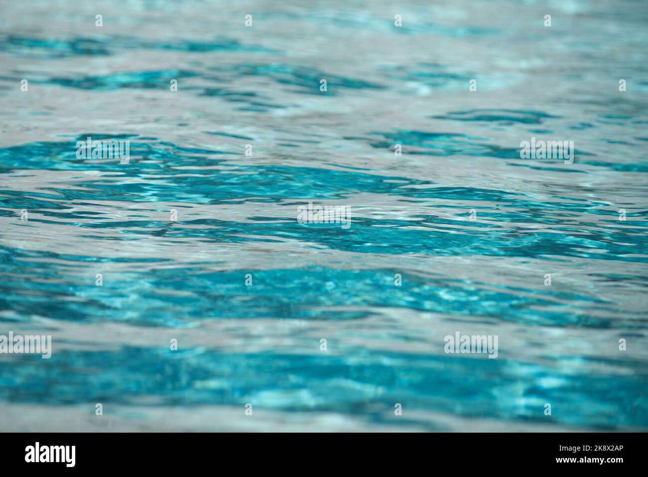 Background of blue water in swimming pool with sun reflection, ripple ...