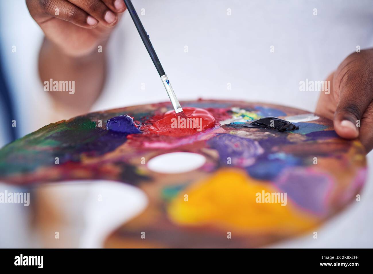 Dont be afraid of color. an unrecognizable woman holding a painters ...