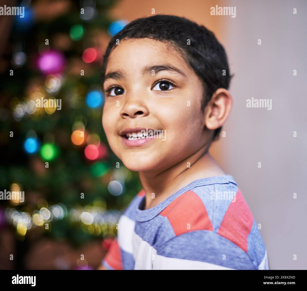 Did someone say presents. a cheerful little boy looking into the ...