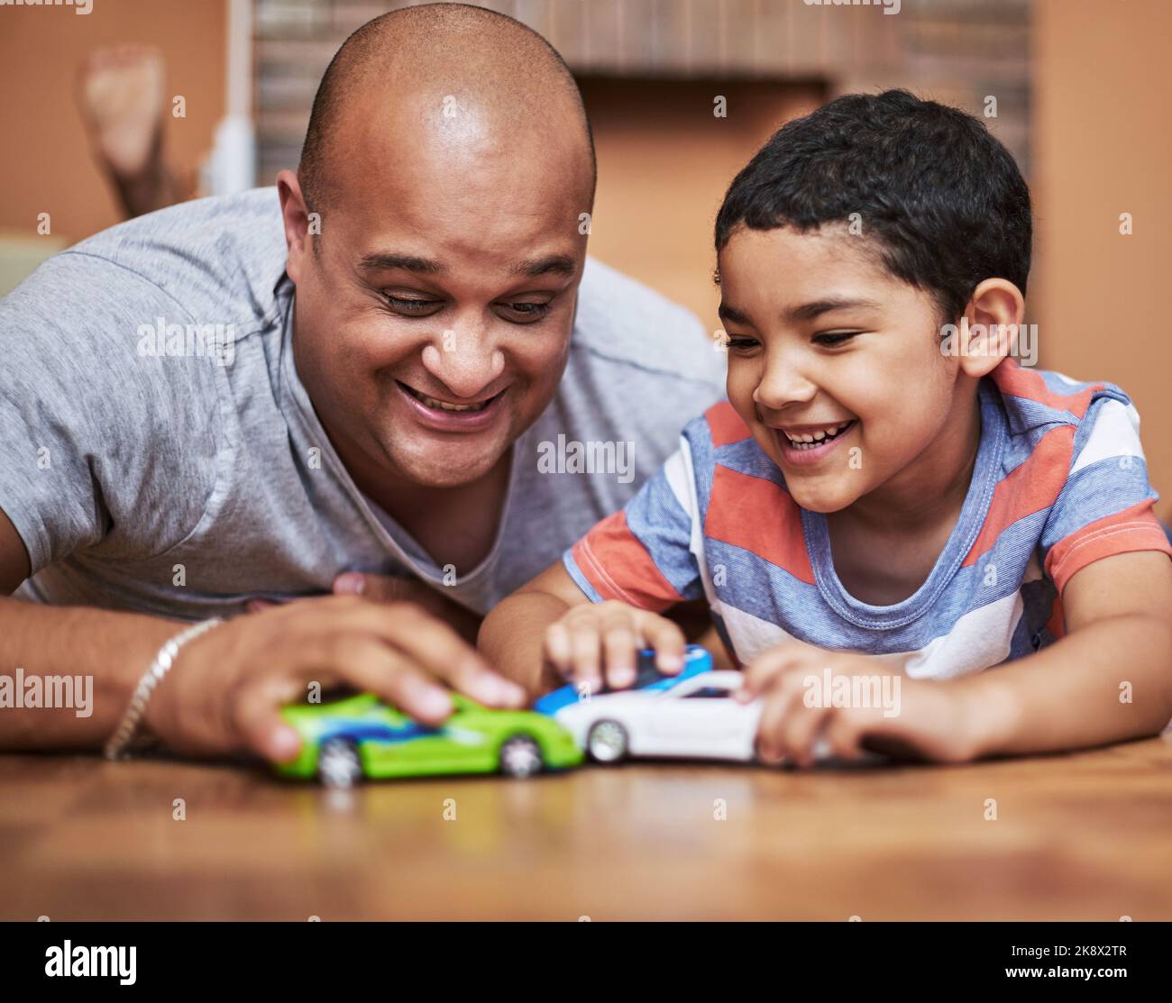 Lets start the race. a cheerful little boy and his father playing with ...