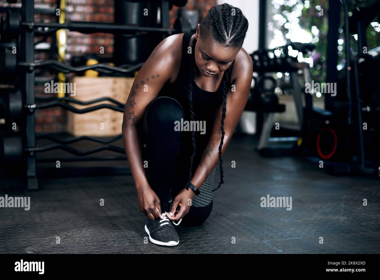 Its time to lace up. Full length shot of an attractive young female ...