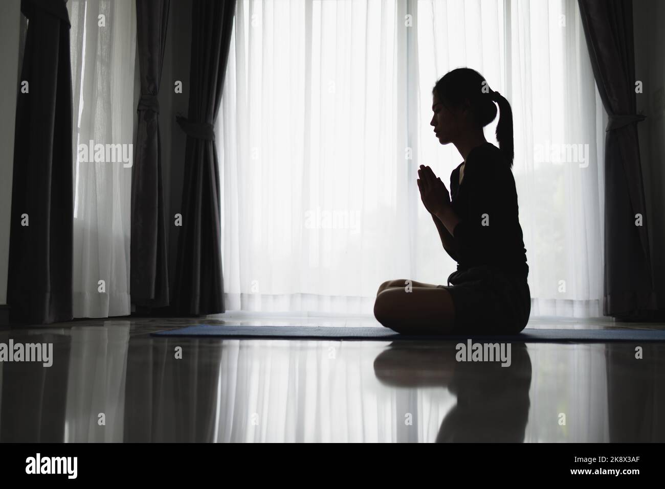 Silhouette of woman prayer position, Praying hands with faith in ...