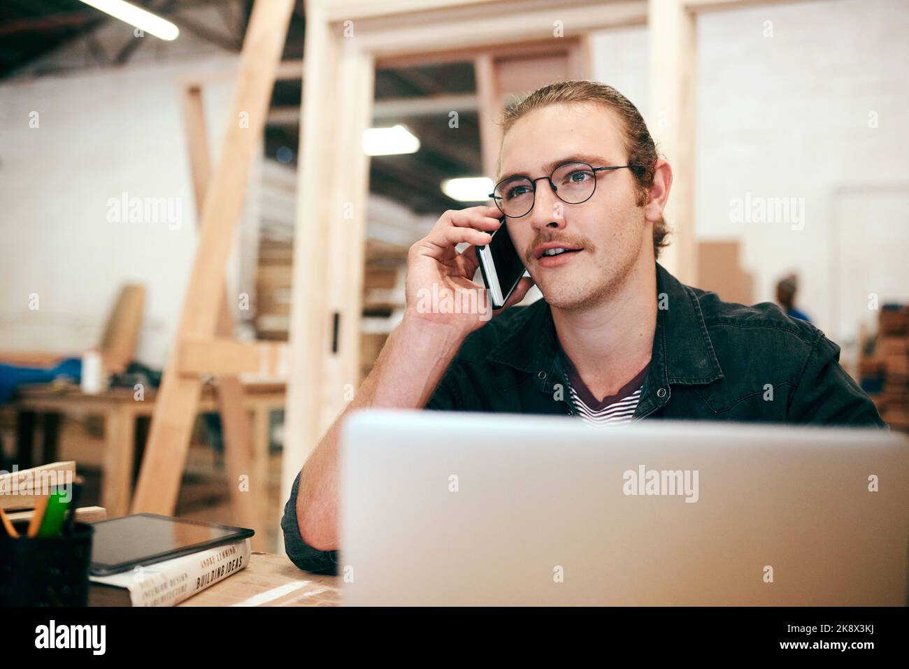 I always keep in contact with my clients. a young carpenter making a ...
