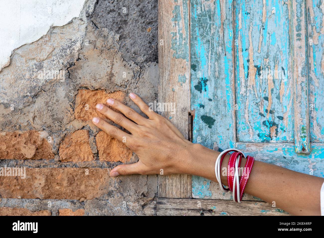 Girl's hand with red and white leather bracelets on background of old ...