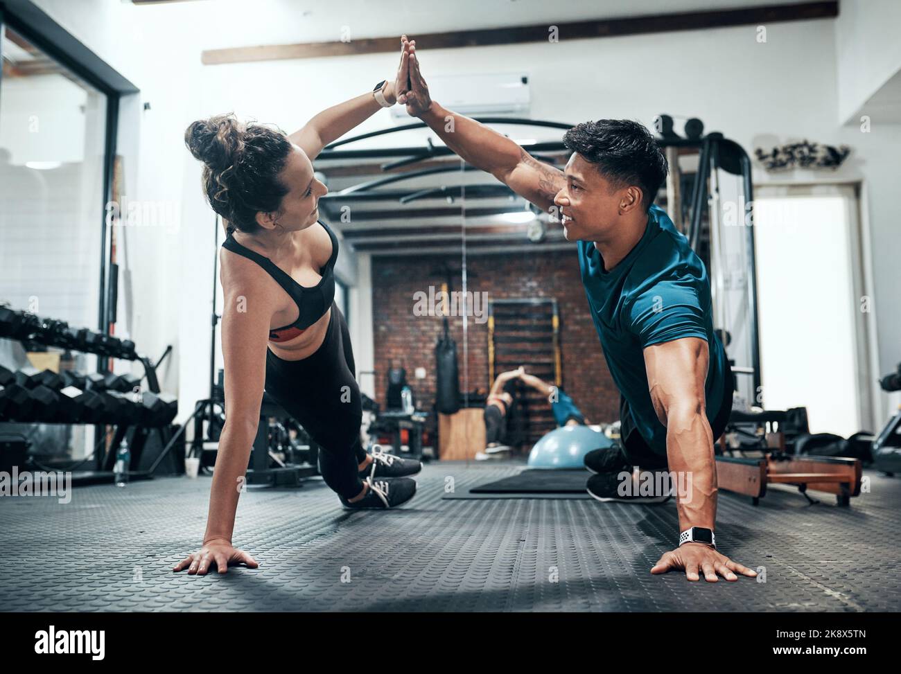 We achieve more when we workout together. two sporty young people ...