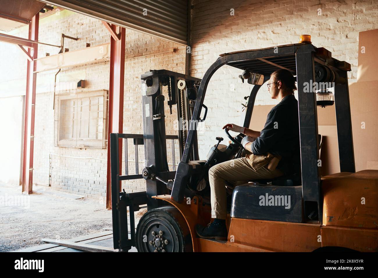 I keep things moving on the warehouse floor. a young male warehouse ...