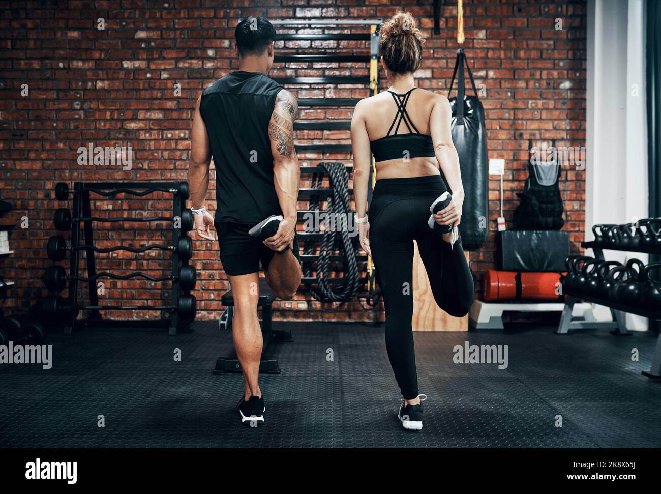 Getting our bodies into shape. two sporty young people working out together at the gym Stock ...