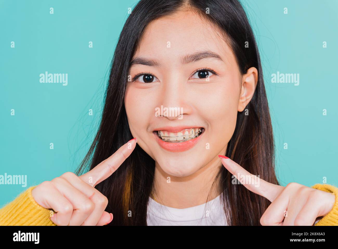 Asian beautiful young woman teen pointing finger to teeth, portrait of ...