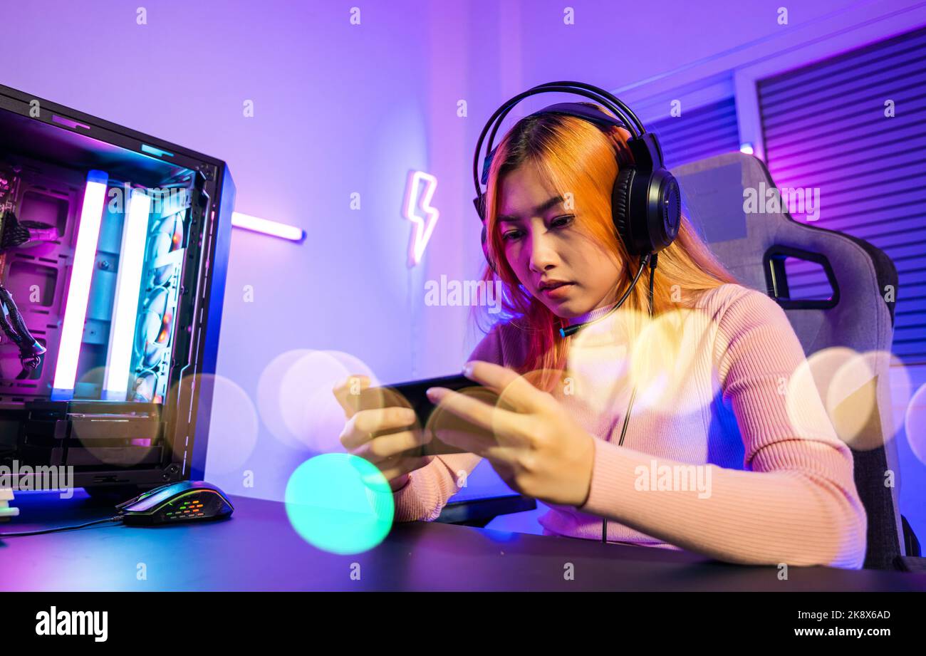 Losing. Gamer in playing video game online with smartphone with neon ...