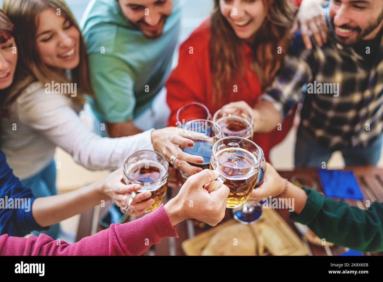 Group of millennial friends drinking and toasting beer at brewery bar ...