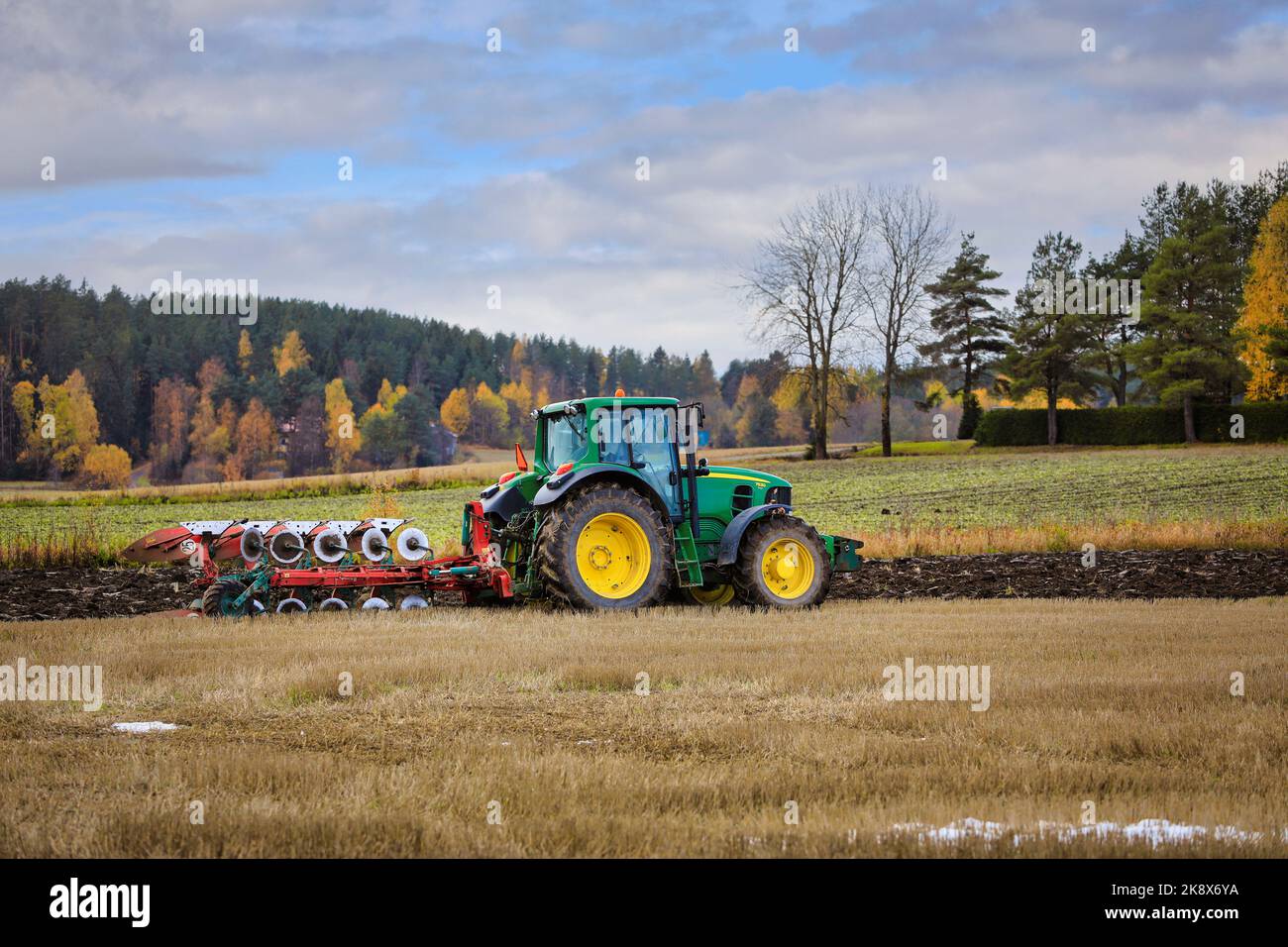 Farmer ploughing a stubble field with John Deere 7530 tractor and ...