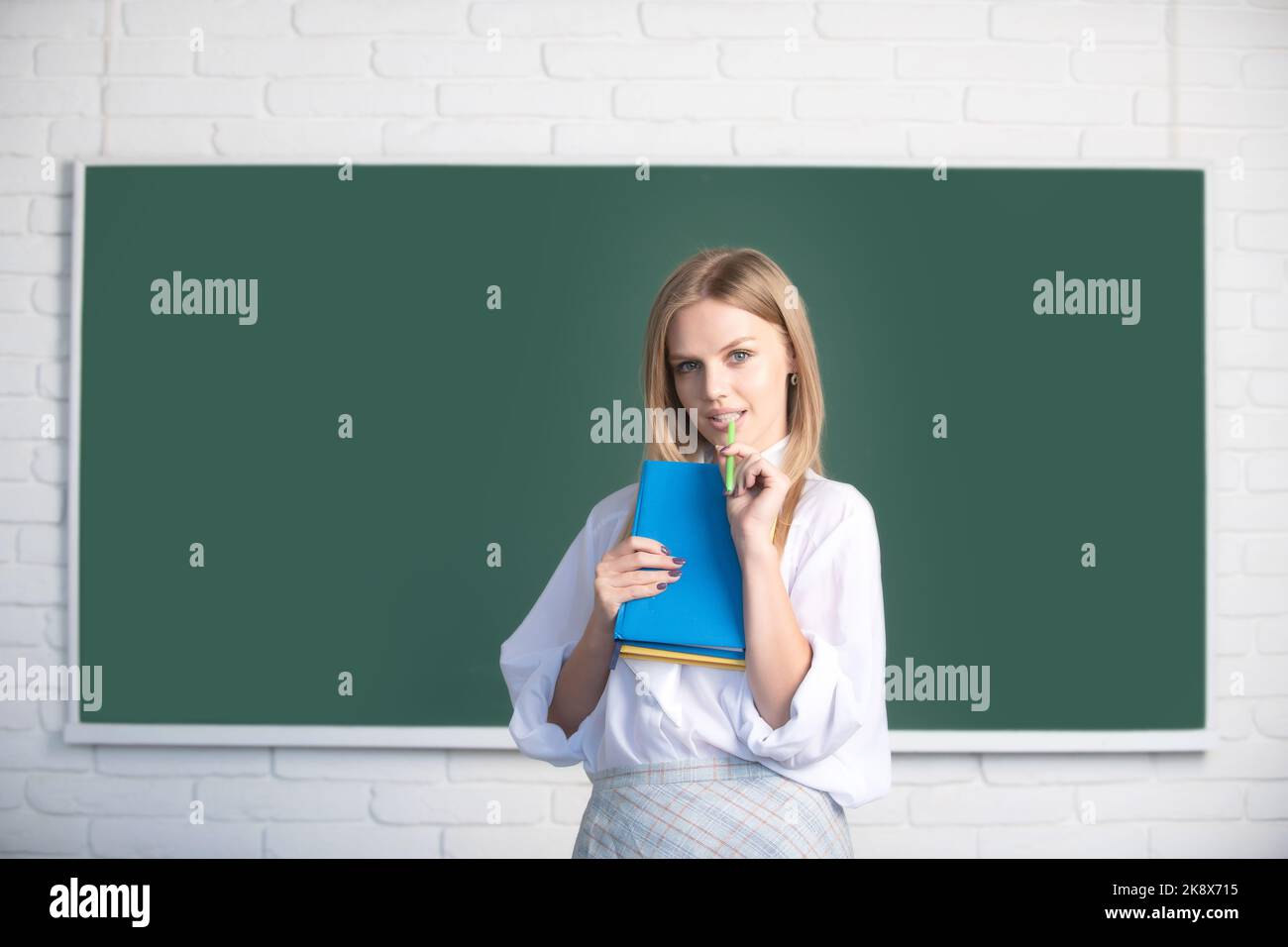 Student preparing exam and learning lessons in school classroom. Female ...