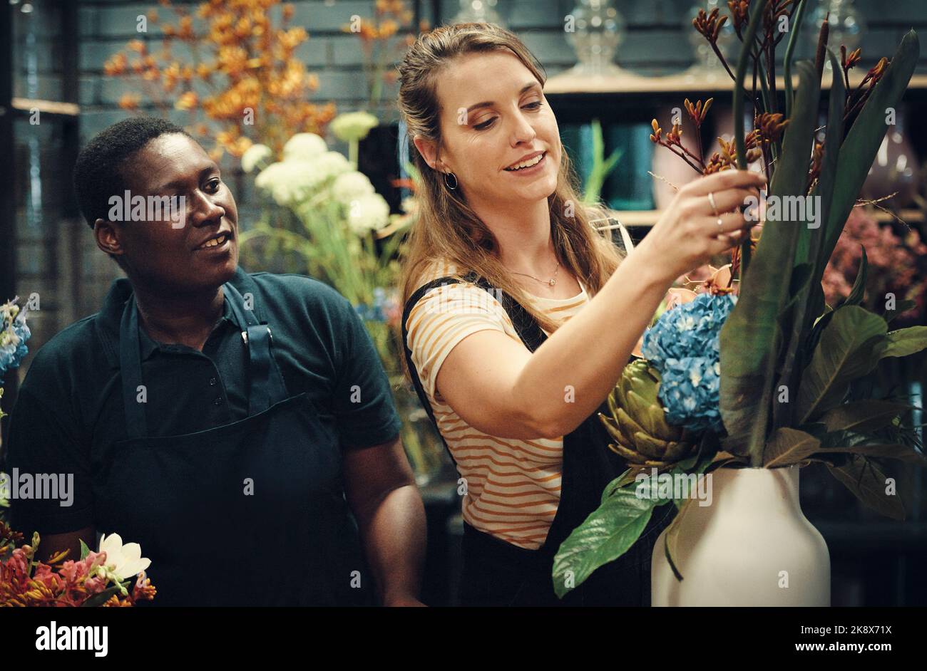 Lets fix this quickly. two attractive young florists standing together ...