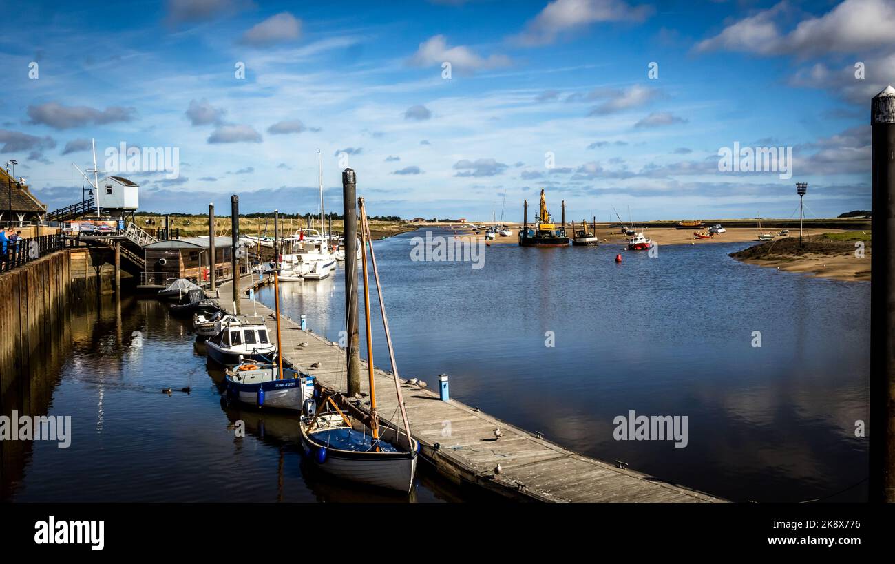 Estuary with boats and a jetty at Wells Norfolk Stock Photo - Alamy