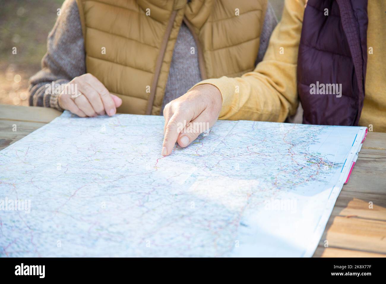 Detail of a hiker's hands marking the route on a mountain map Stock ...