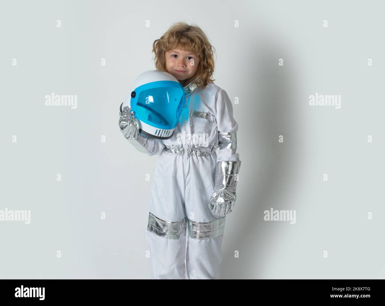 Cute little boy spaceman child in space suit holding helmet isolated on ...