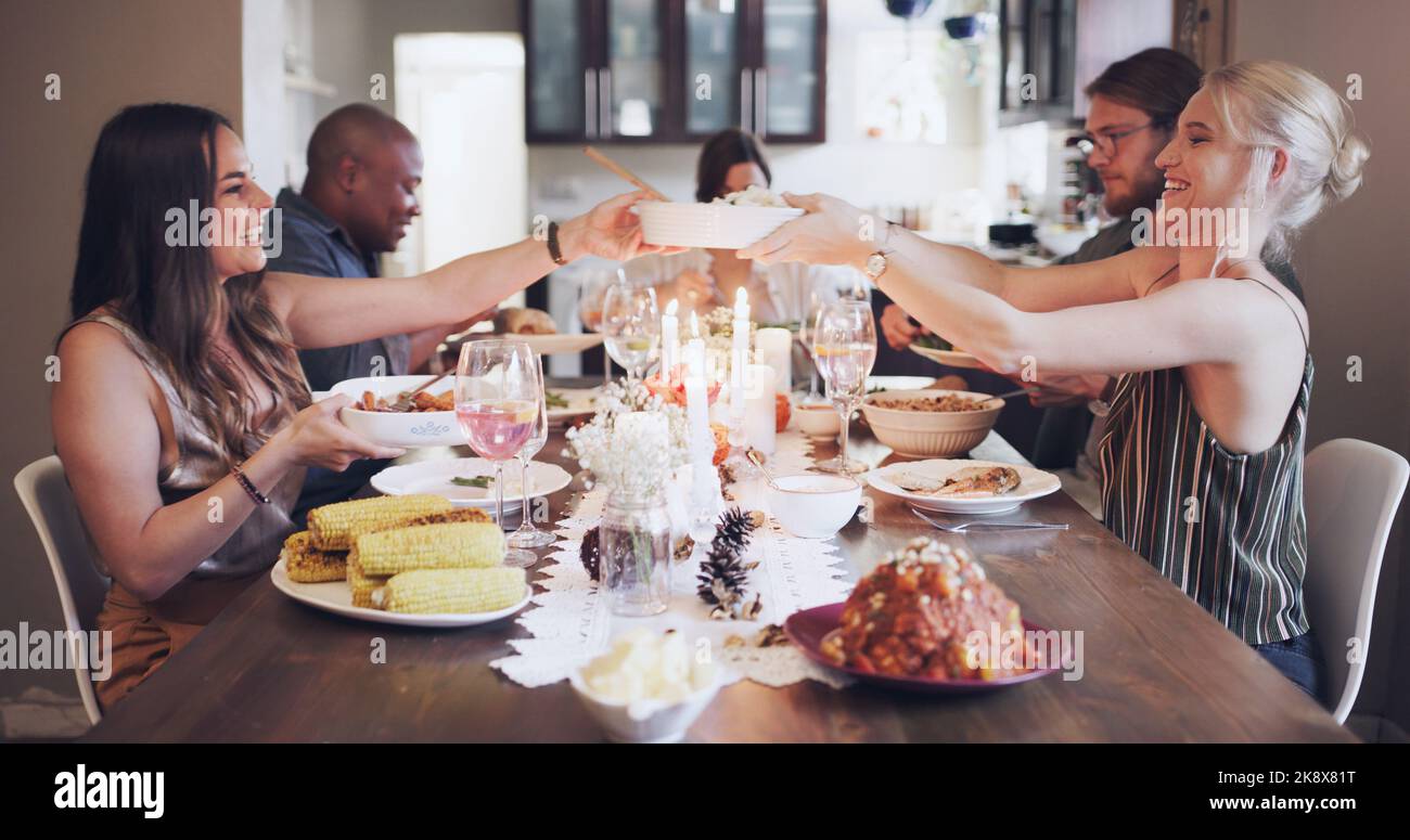 Lets get to feasting. a group of young friends having a festive meal ...