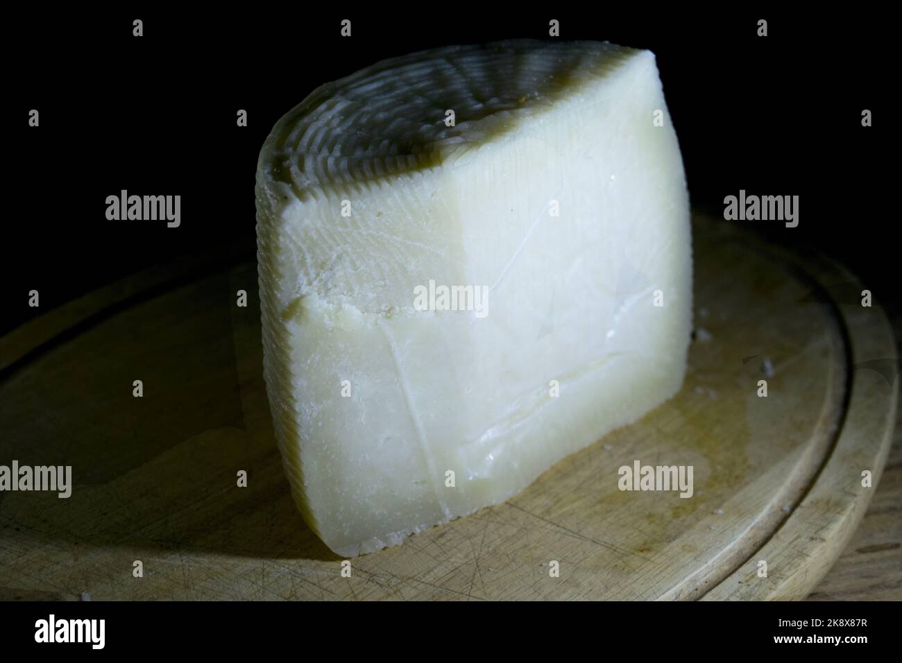 goat cheese in chiaroscuro on a wooden pastry board Stock Photo - Alamy