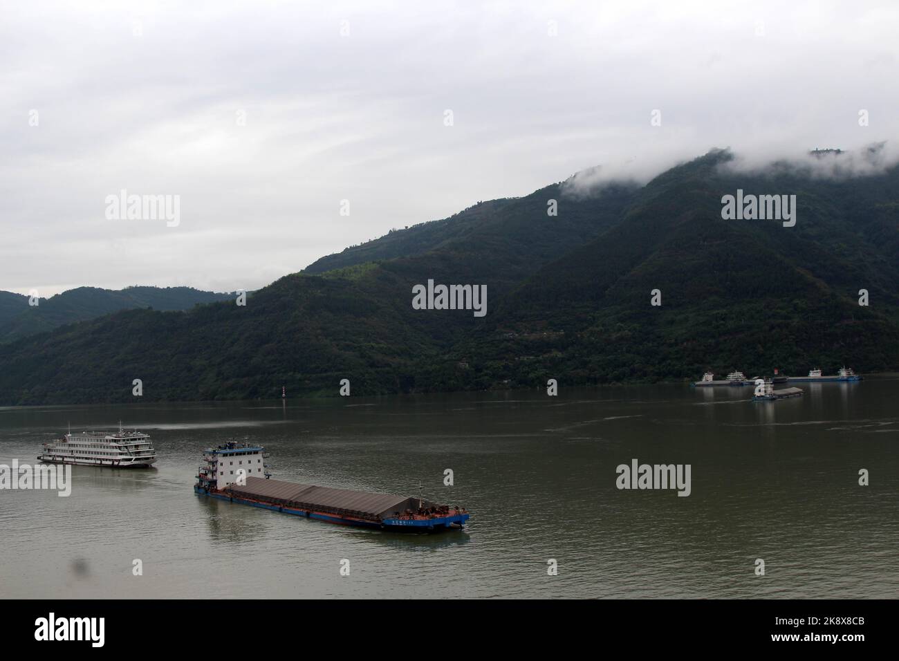 Cargo ships shuttle back and forth in the Yangtze river channel, also ...