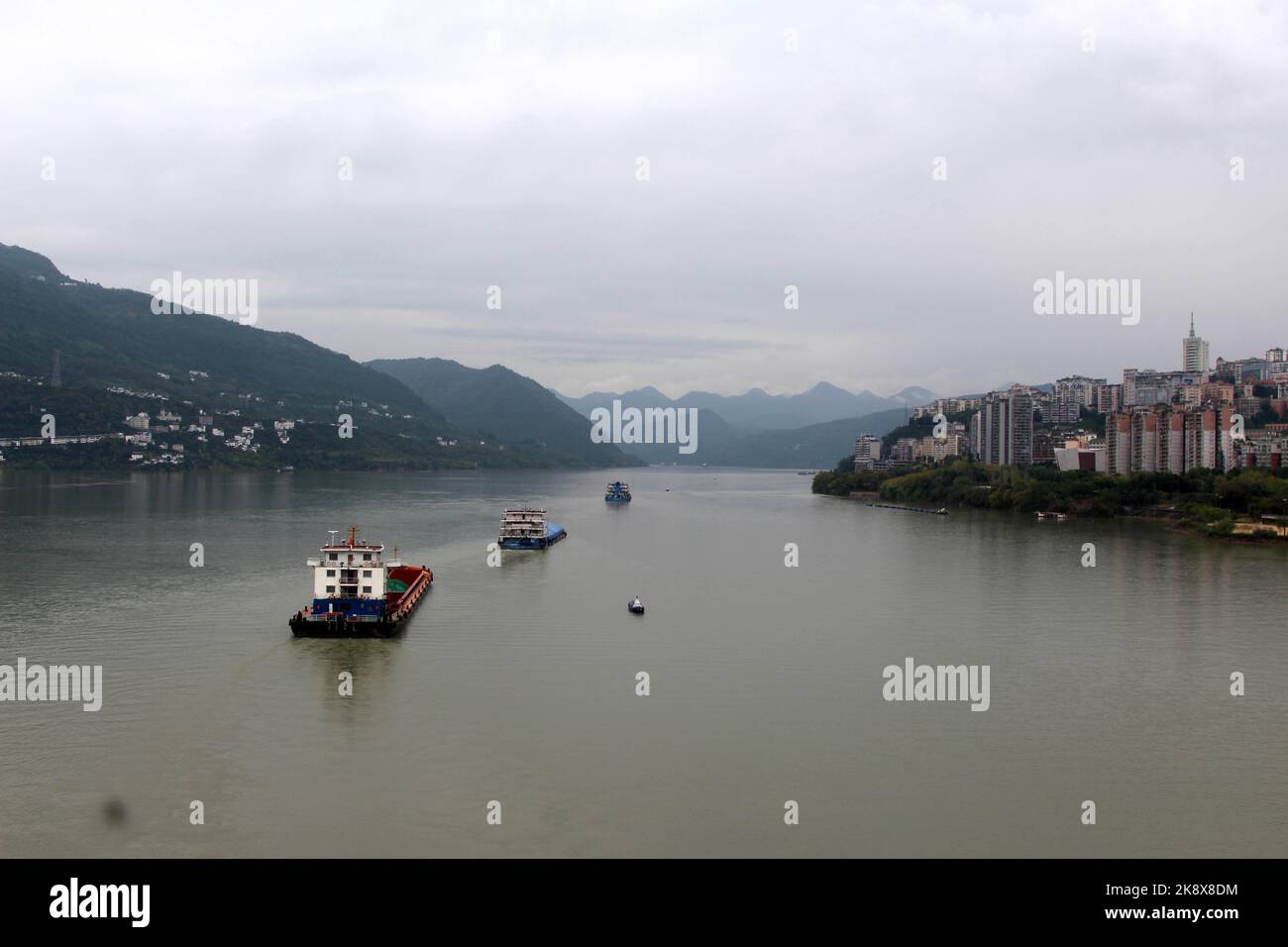 Cargo ships shuttle back and forth in the Yangtze river channel, also ...