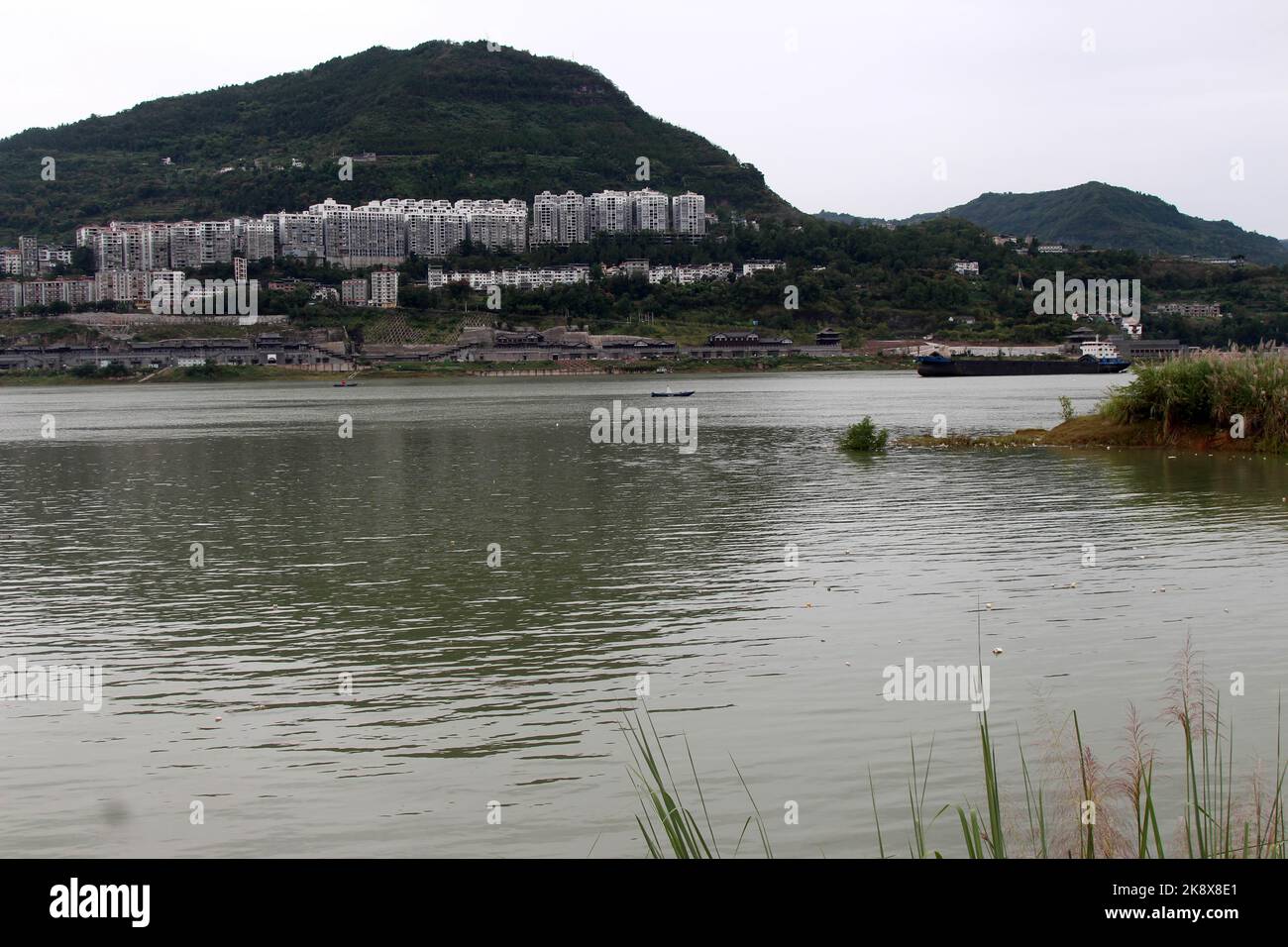 Cargo ships shuttle back and forth in the Yangtze river channel, also ...
