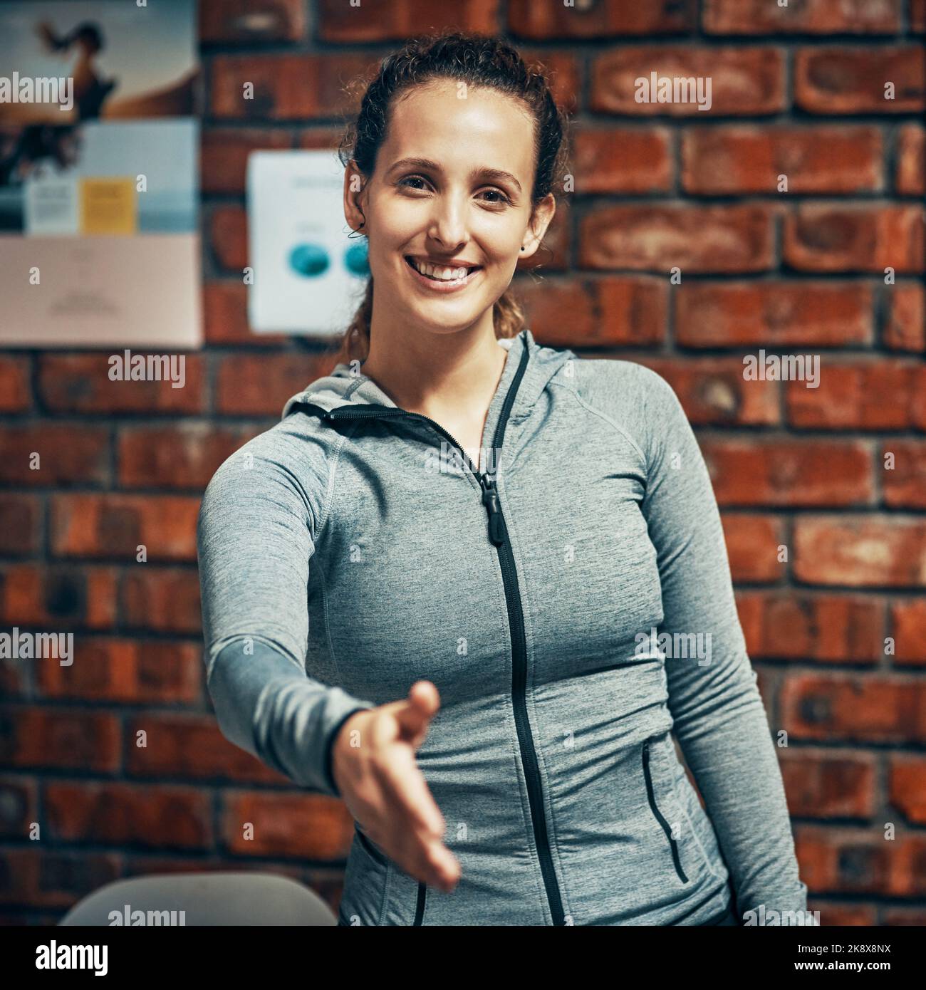 Im your new instructor. a fitness instructor extending her arm for a ...