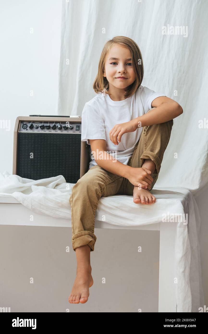 Cute Tween Girl Sitting On A Table Barefoot Next To A Guitar Amp Cute Tween Girl Sitting On A Table Barefoot Next To A Guitar Amp