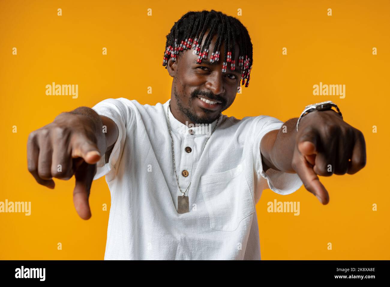 Young african man pointing to camera with fingers isolated on yellow ...