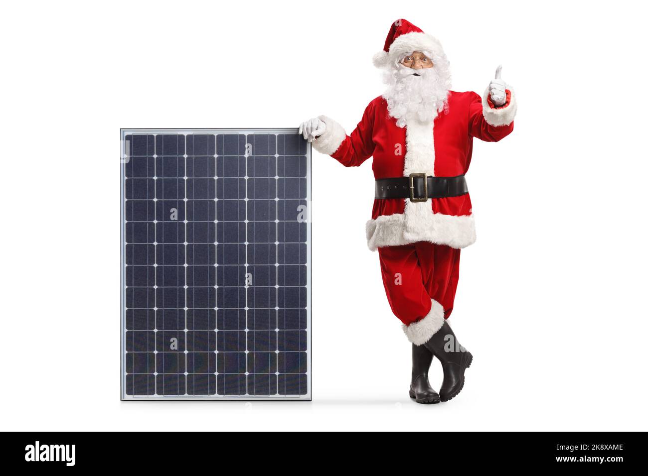 Santa claus leaning on a big solar panel and showing thumbs up isolated ...