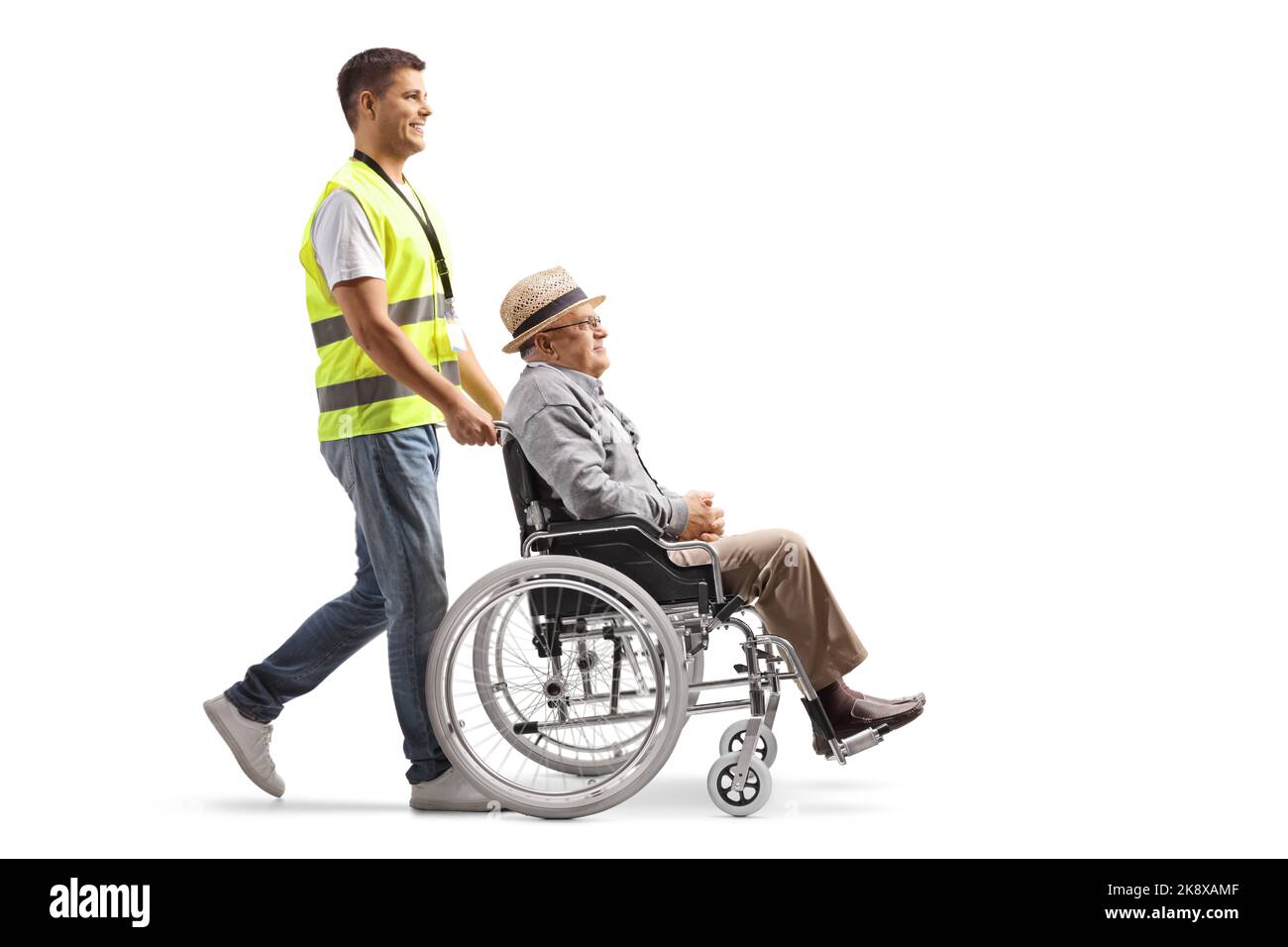 Full length profile shot of a community worker pushing an elderly ...