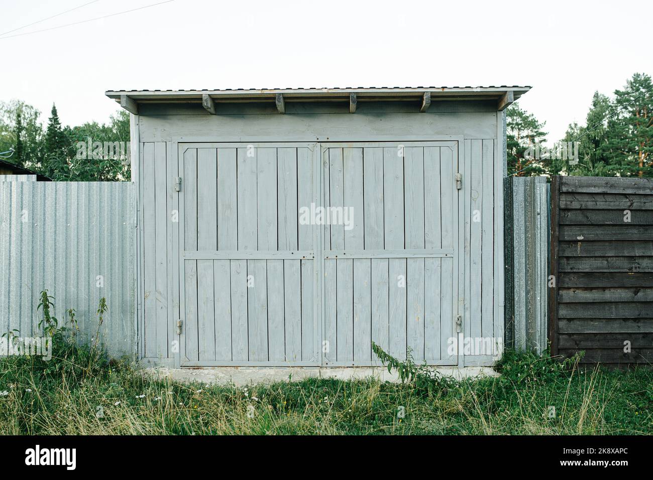 Rustic car garage, made of planks and metal frame, neatly painted ...