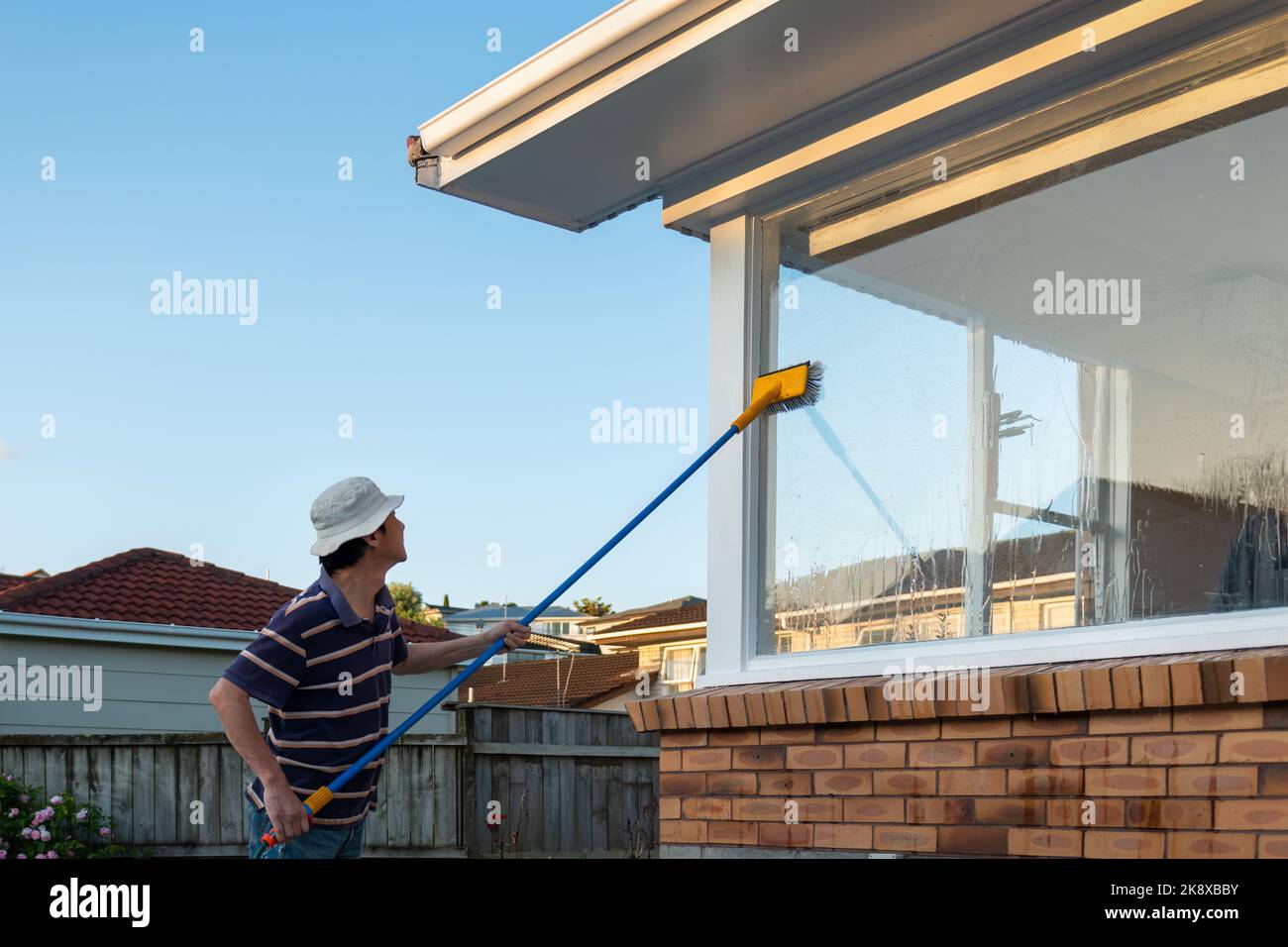 Man window cleaner cleaning long pole hi-res stock photography and ...