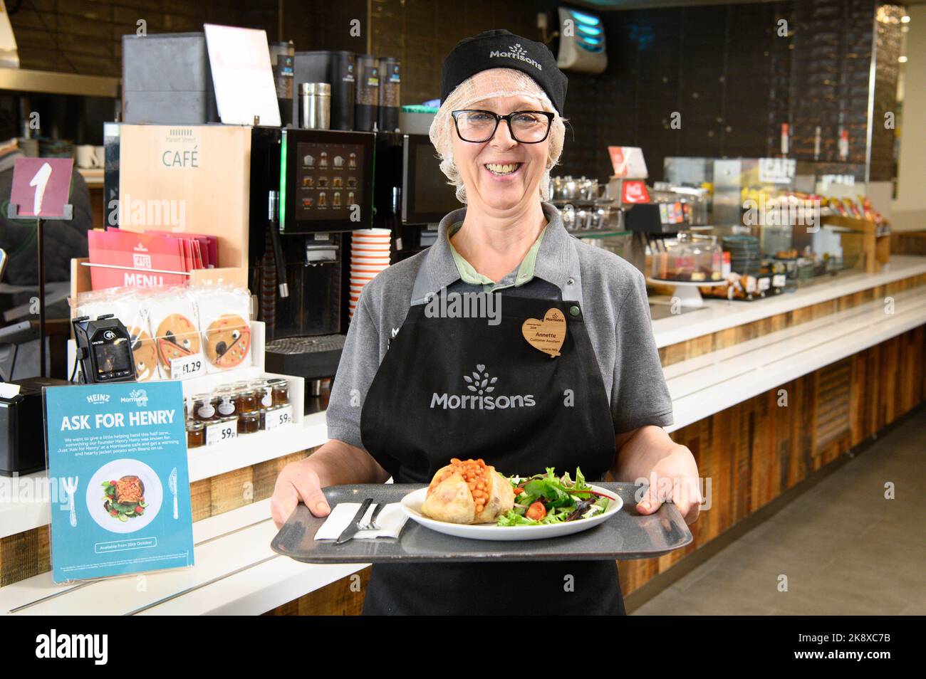 EDITORIAL USE ONLY Customer assistant, Annette prepares to serve ...