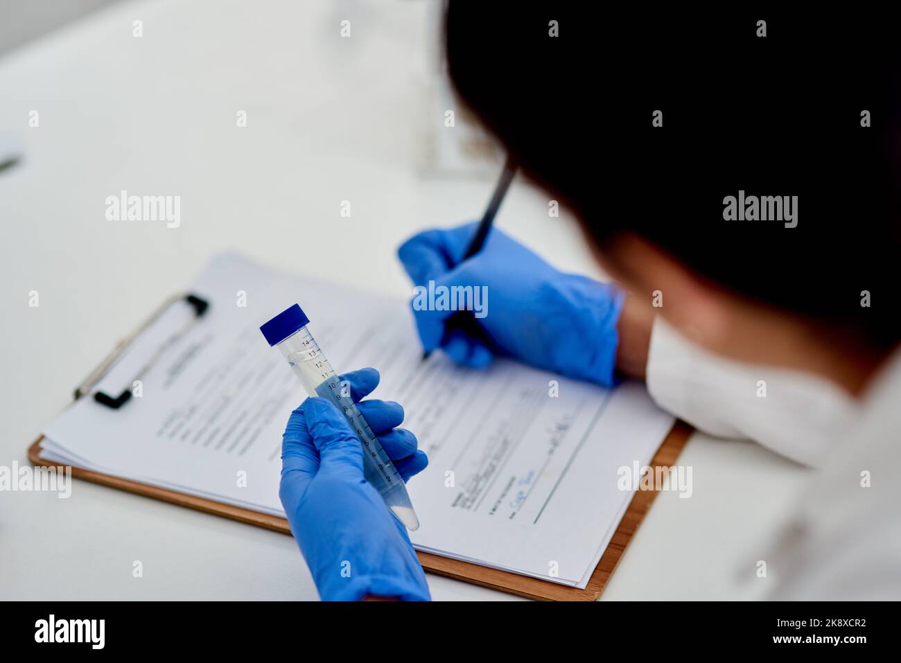 Noting down the correct quantities for her tests. Closeup shot of an ...