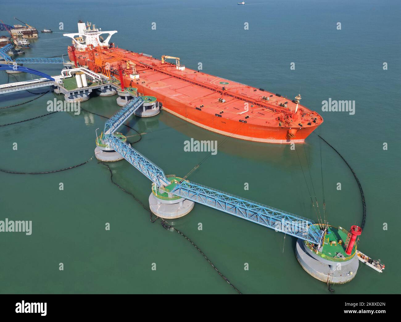 An oil tanker discharged oil through a pipeline at the 300000 ton crude ...