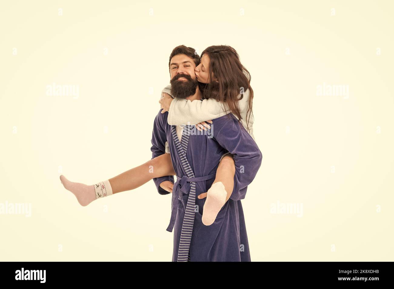 Romantic girl kissing and hugging happy man giving her piggyback ride ...