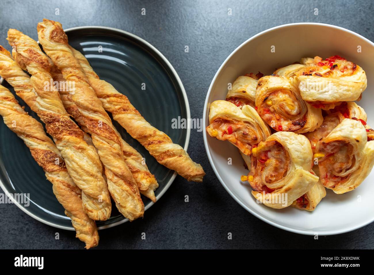 a roll of puff pastry with the addition of cheese, ham and pepper in ...