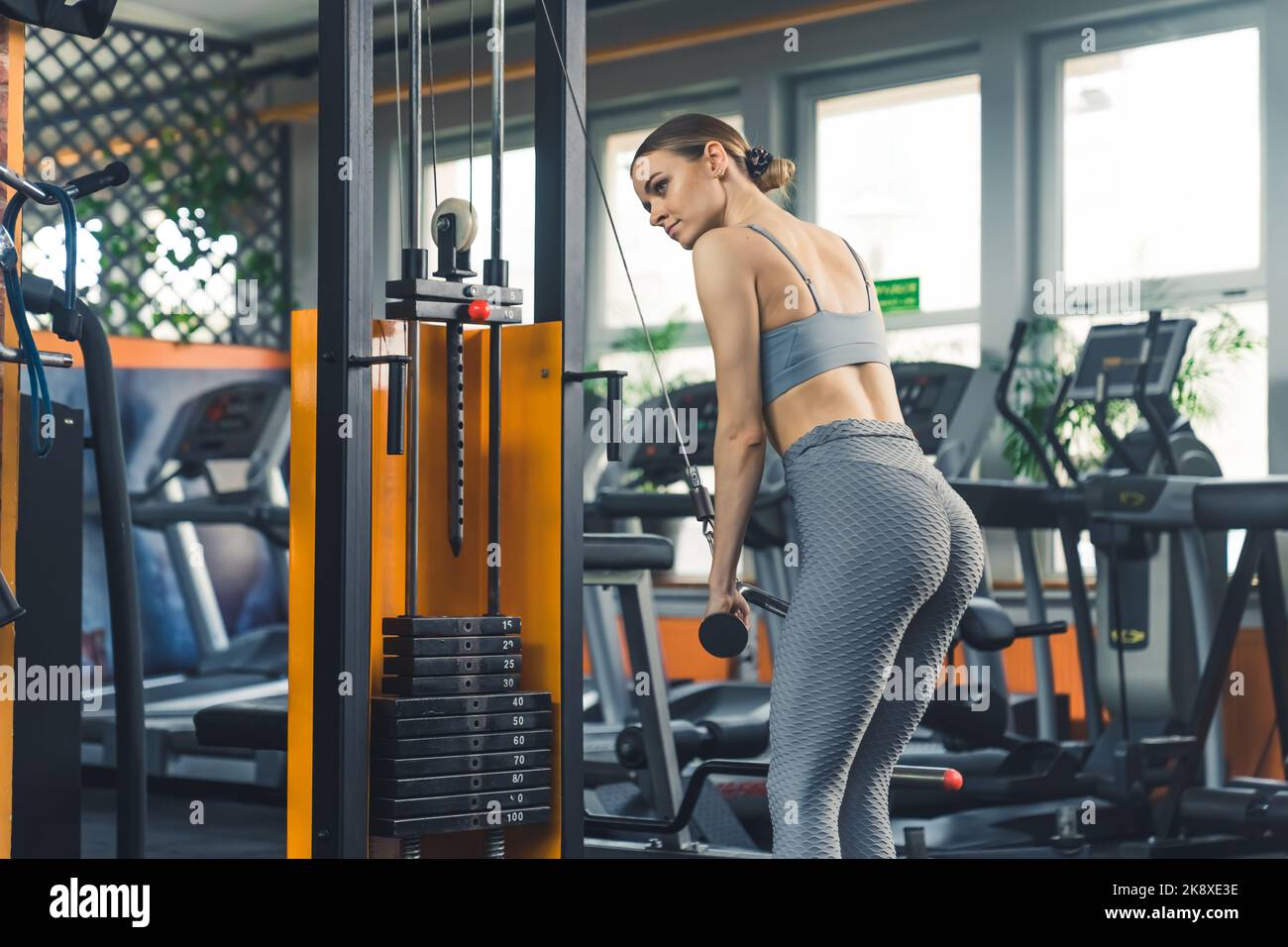 Fit stylish caucasian female model in her 20s wearing gray sportswear ...