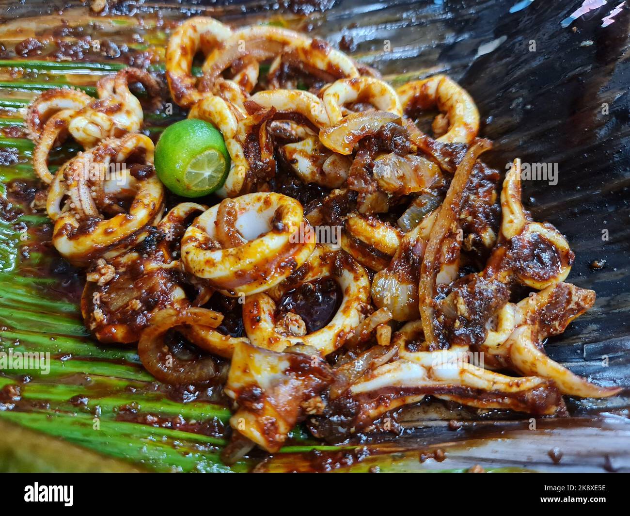 A tasty Sambal Sotong spicy squid with green lemon Stock Photo - Alamy