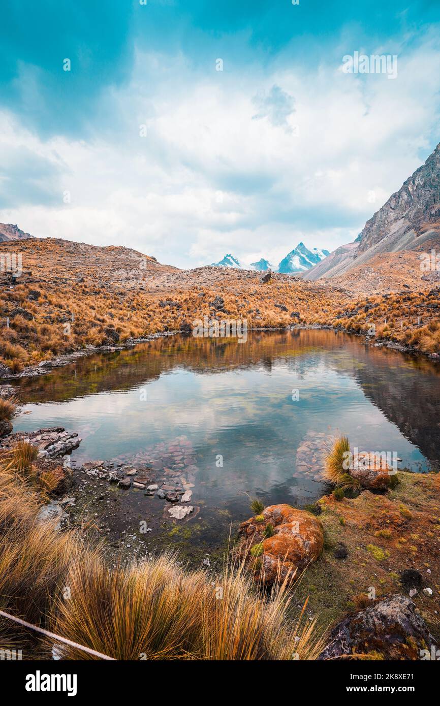 A vertical view of the lake under Nevado Auzangate Mountain in Peru ...