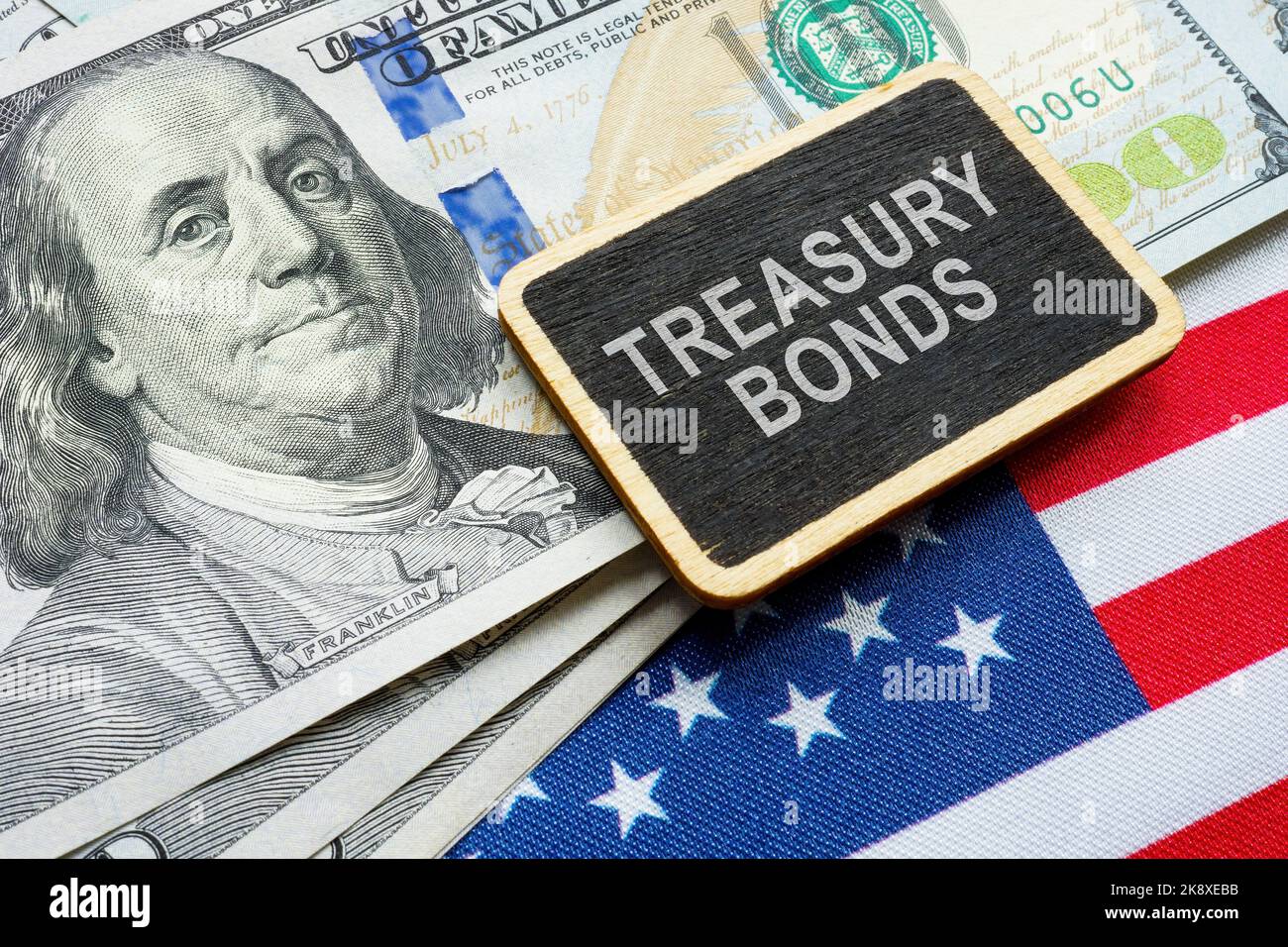 Treasury bonds concept. American flag, dollars and plate Stock Photo ...