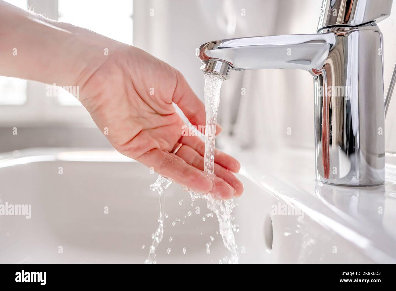 Young woman washes her hands with soap over the sink Stock Photo - Alamy