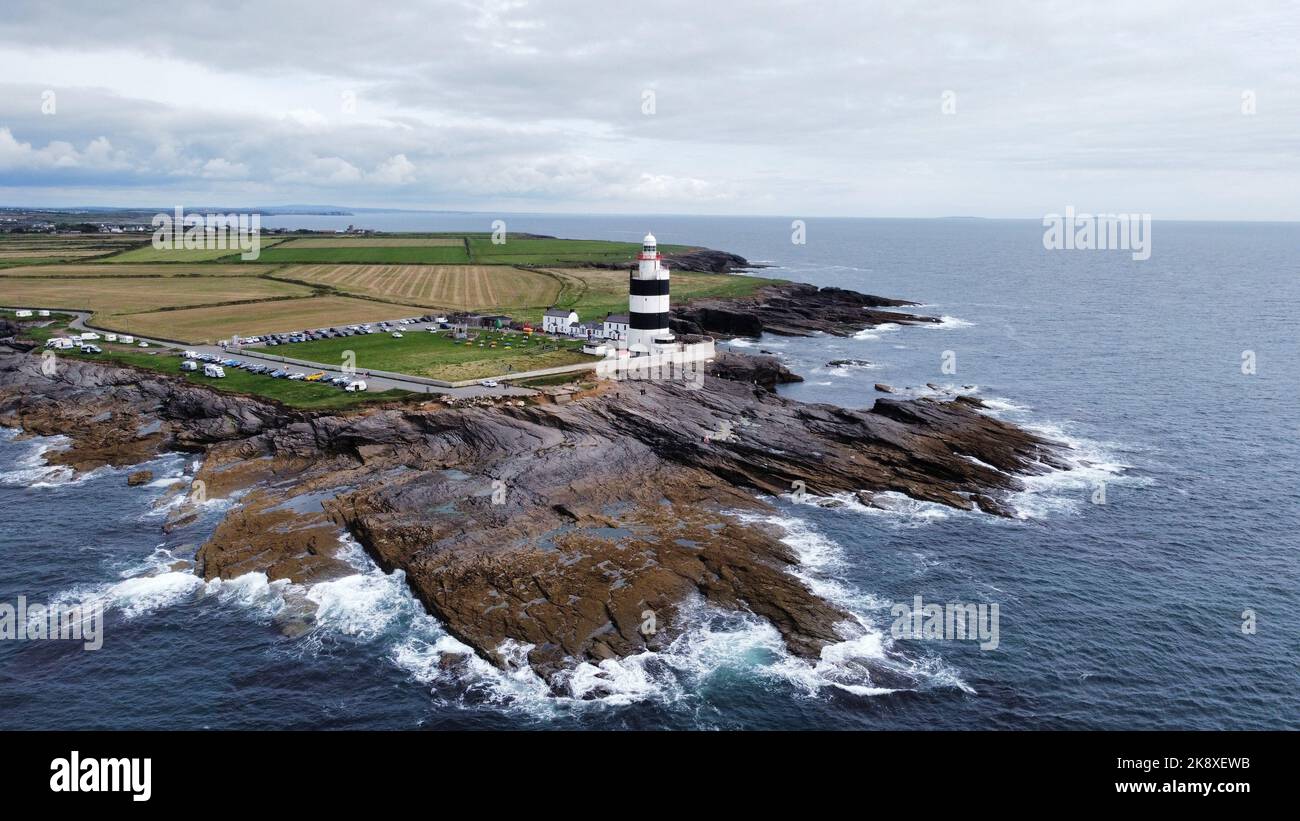 The Hook Head lighthouse surrounded by fields and water below Stock ...